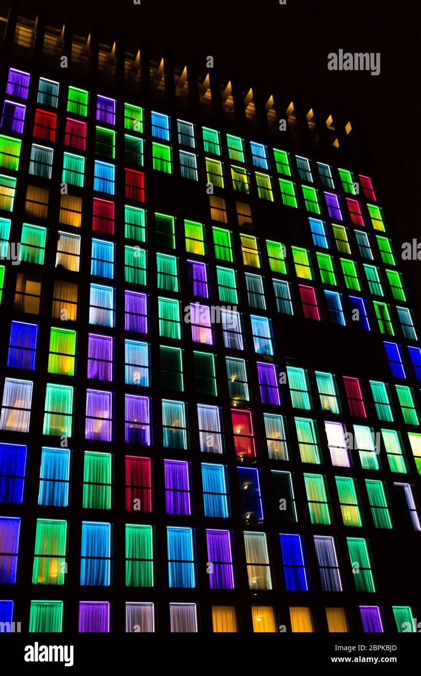 Colored windows texture. Windows illuminated by neon lights background ...