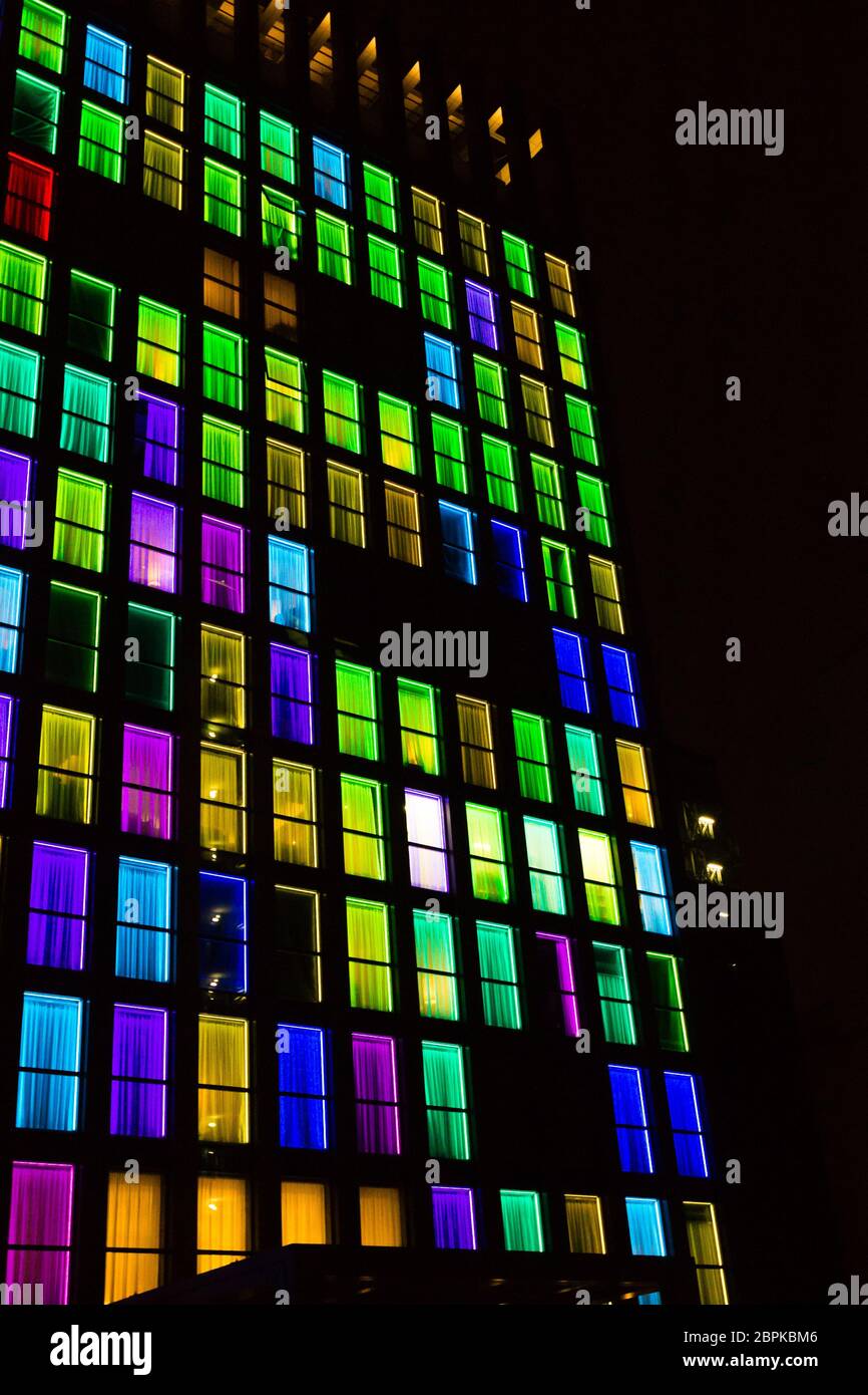 Colored windows texture. Windows illuminated by neon lights background ...