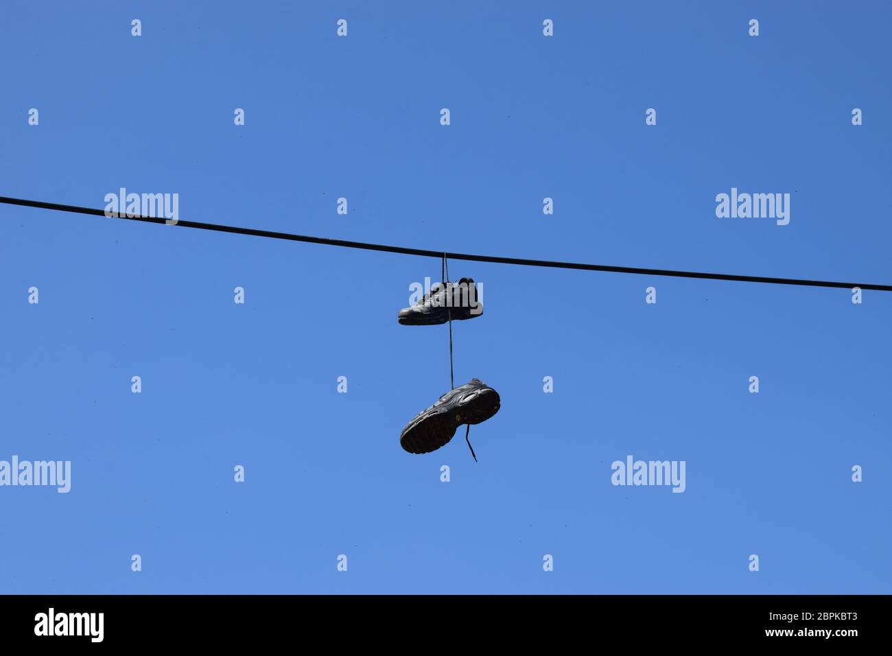 Shoes hanging on electric line hi-res stock photography and images - Alamy