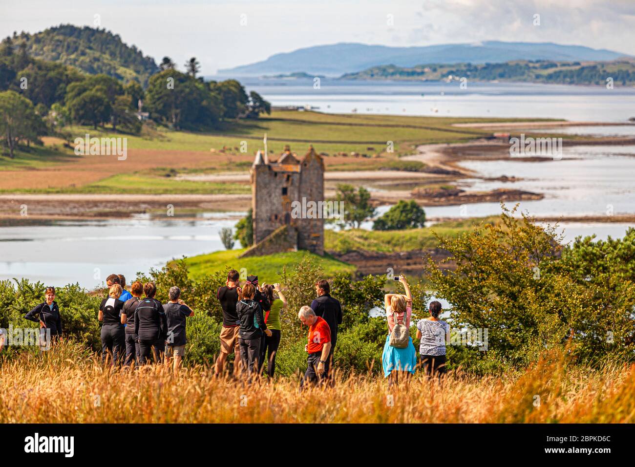 Tourists taking photograph of Castle Stalker near Appin, Scotland Stock ...