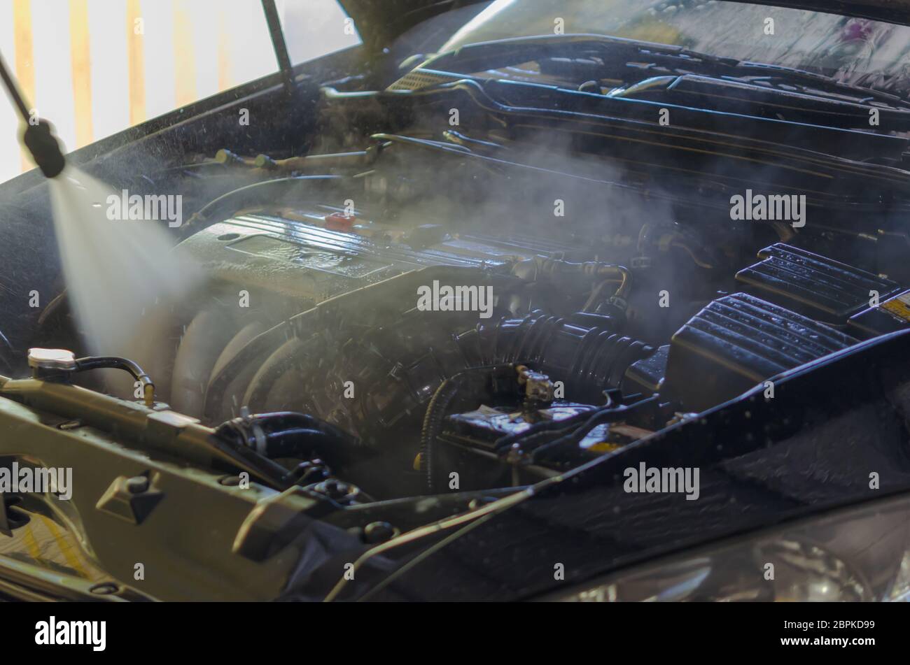 Car engine wash. Use high-pressure water spray Stock Photo - Alamy