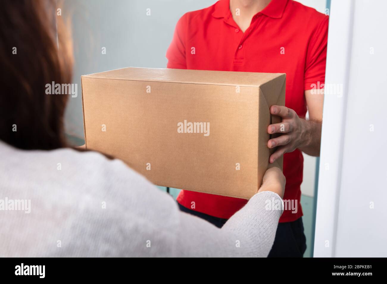 Closeup woman giving cardboard box hi-res stock photography and images ...