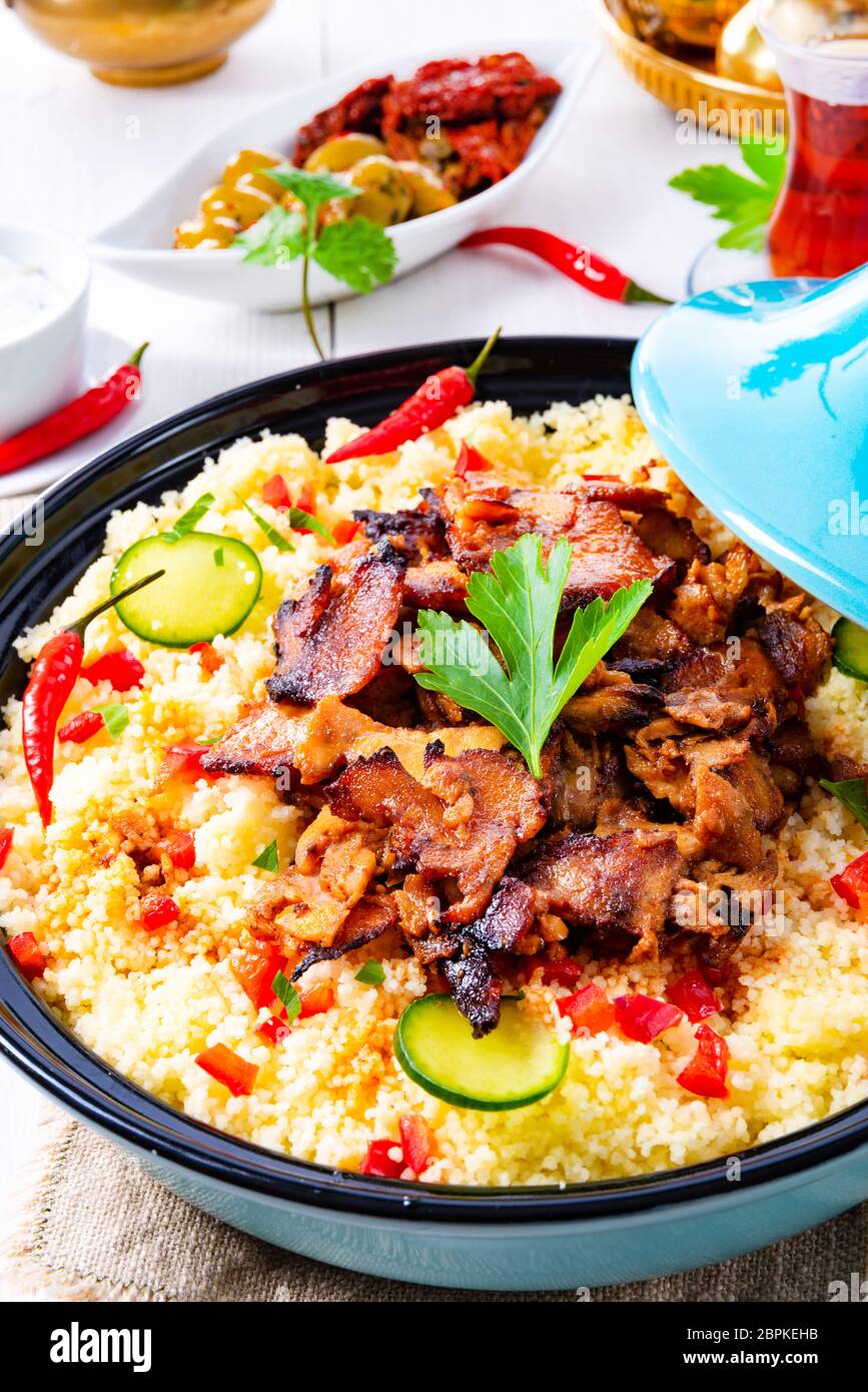 Tajin with couscous, vegetables and meat on white background Stock ...