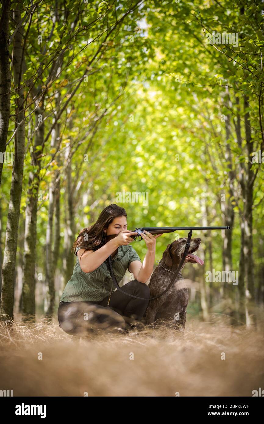 Autumn hunting season. Hunting. Outdoor sports. Woman hunter in the ...