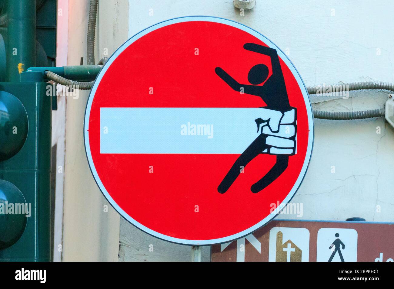 Road sign with an hand that break out the signal, street art ...