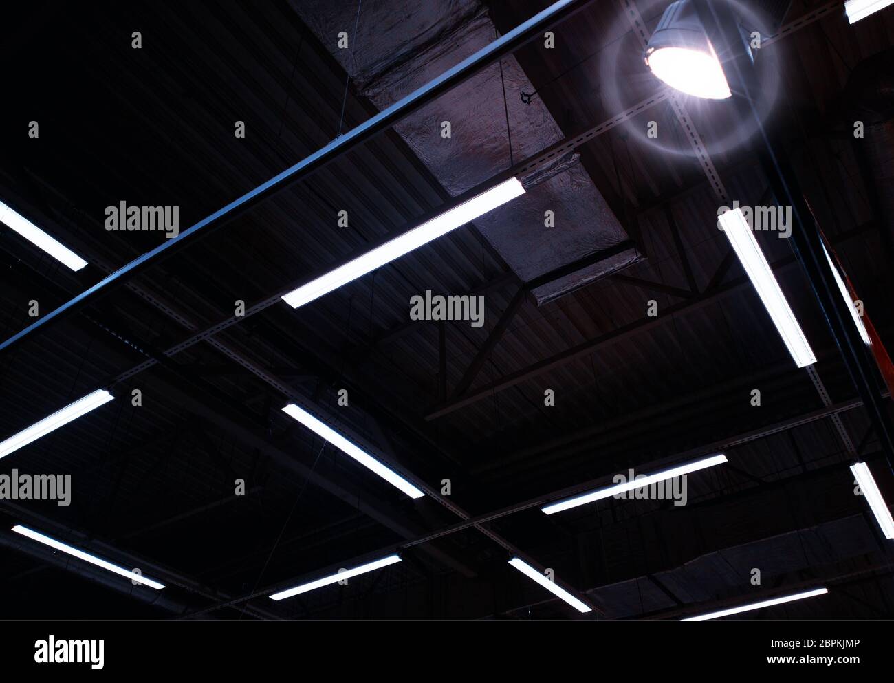 Dramatic lamp illuminating hangar ceiling Stock Photo - Alamy