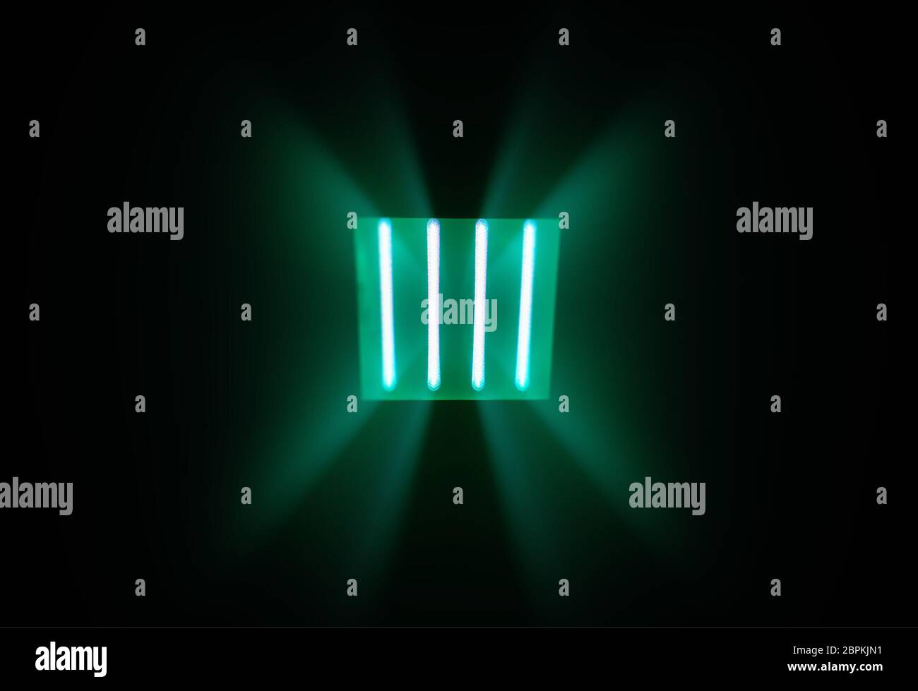 Dramatic green rays from neon lamps background Stock Photo - Alamy