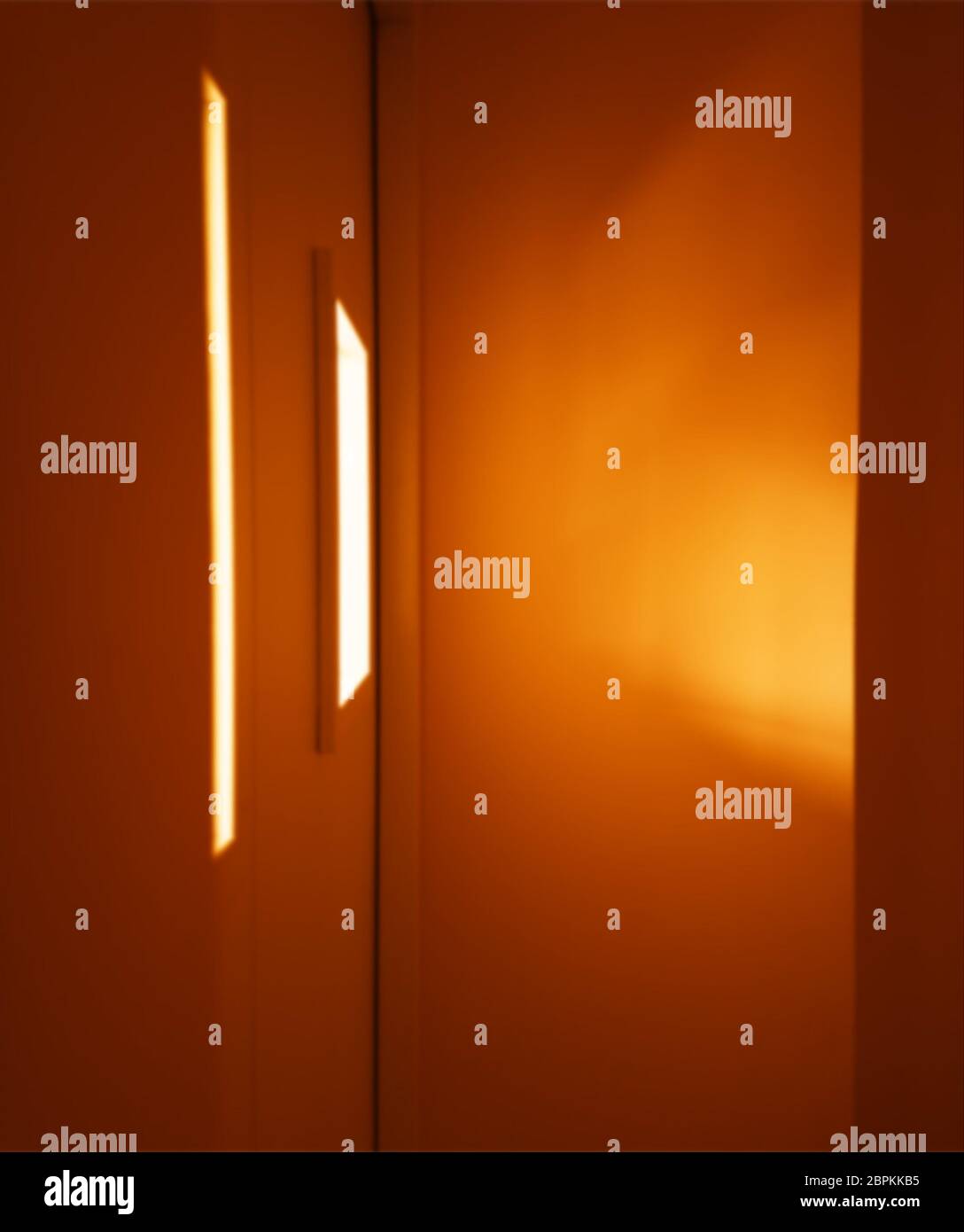 Dramatic light leak coming through closed door background Stock Photo ...