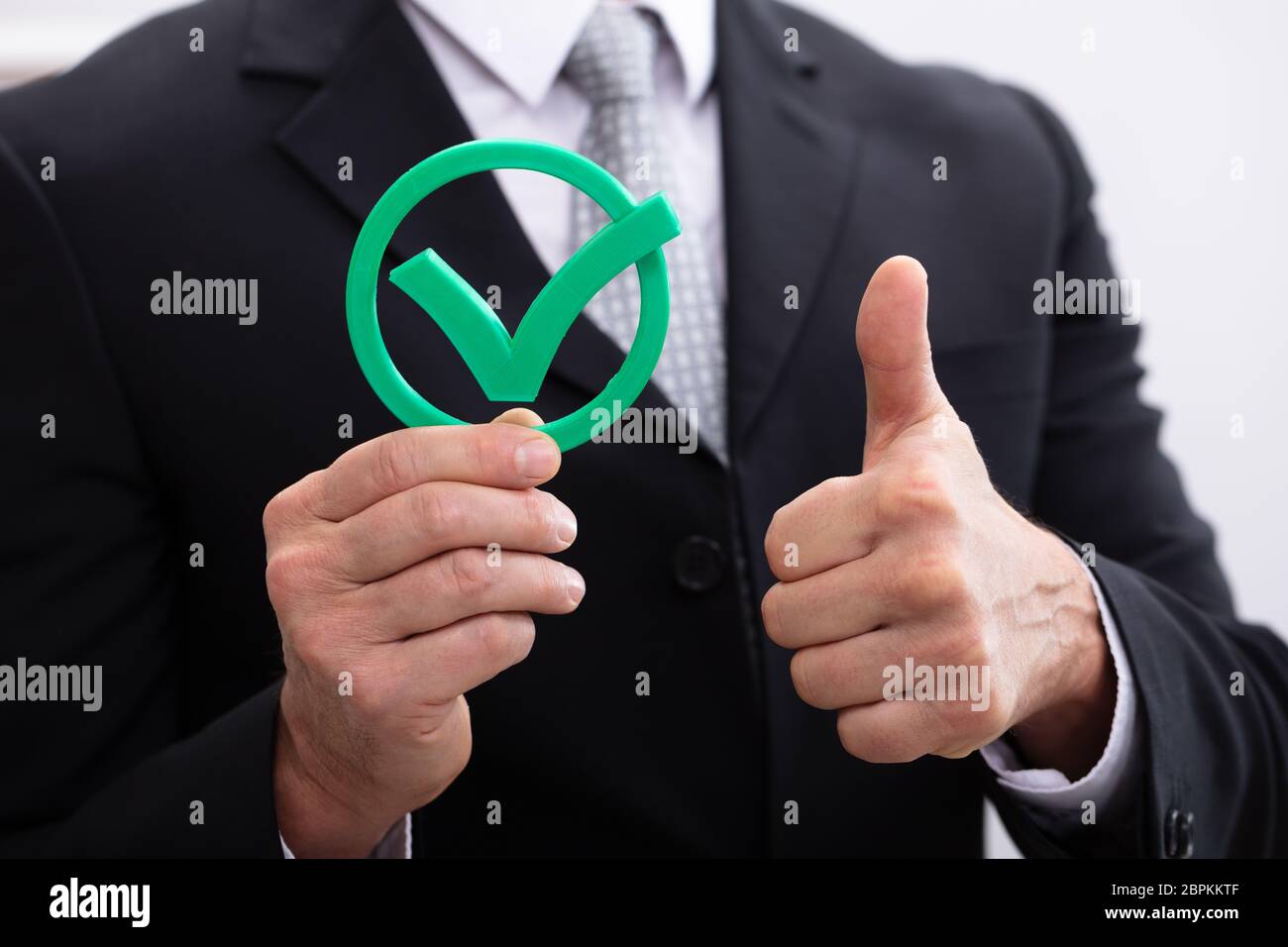Close-up Of A Businessman Hand Holding Green Check Mark Icon Stock ...