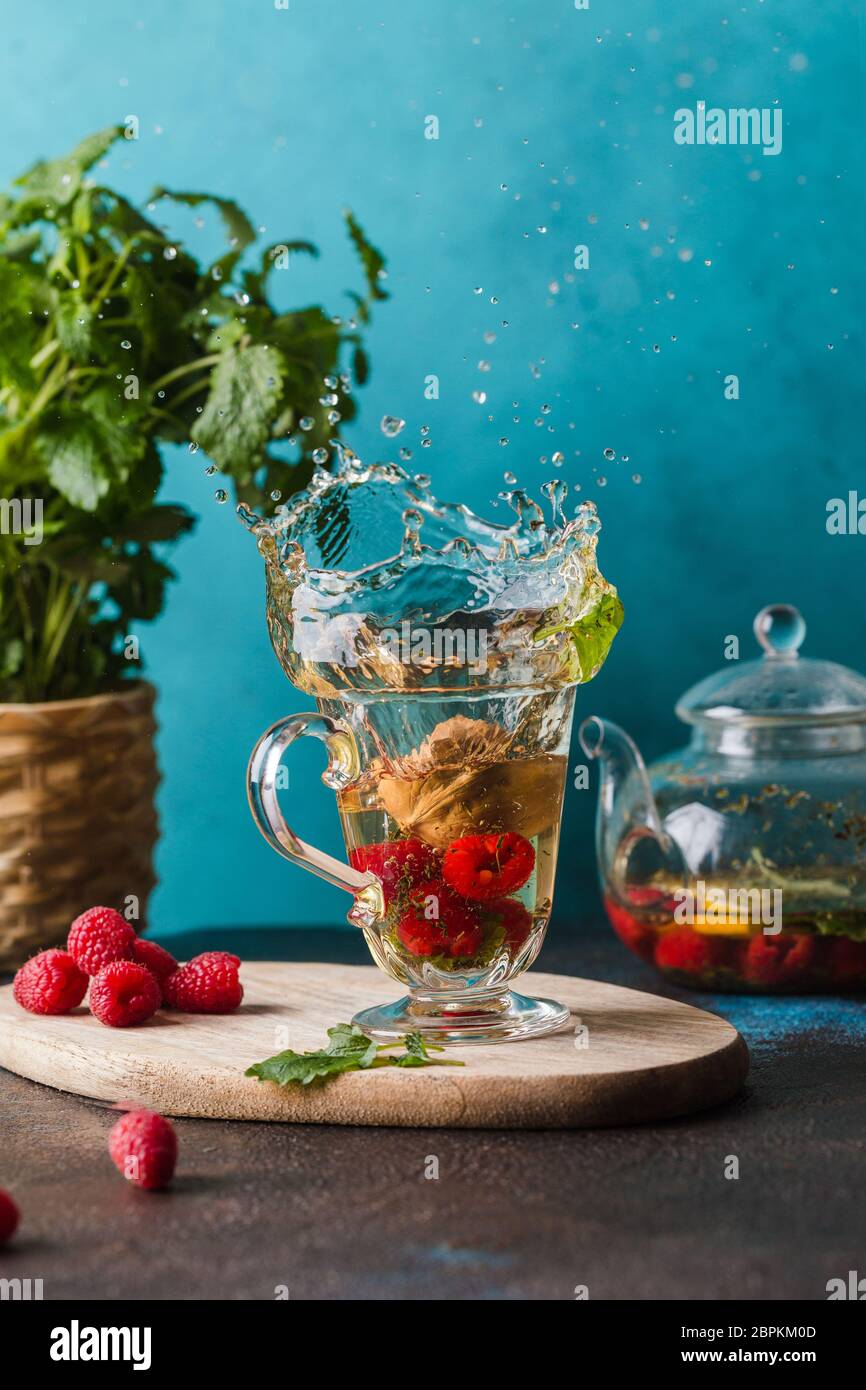 raspberry mint tea on wooden board with splash Stock Photo - Alamy
