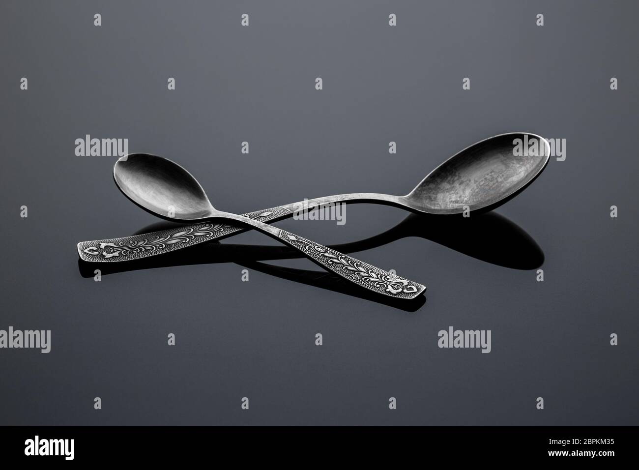 Old nickel silver spoons on a reflective surface Stock Photo - Alamy