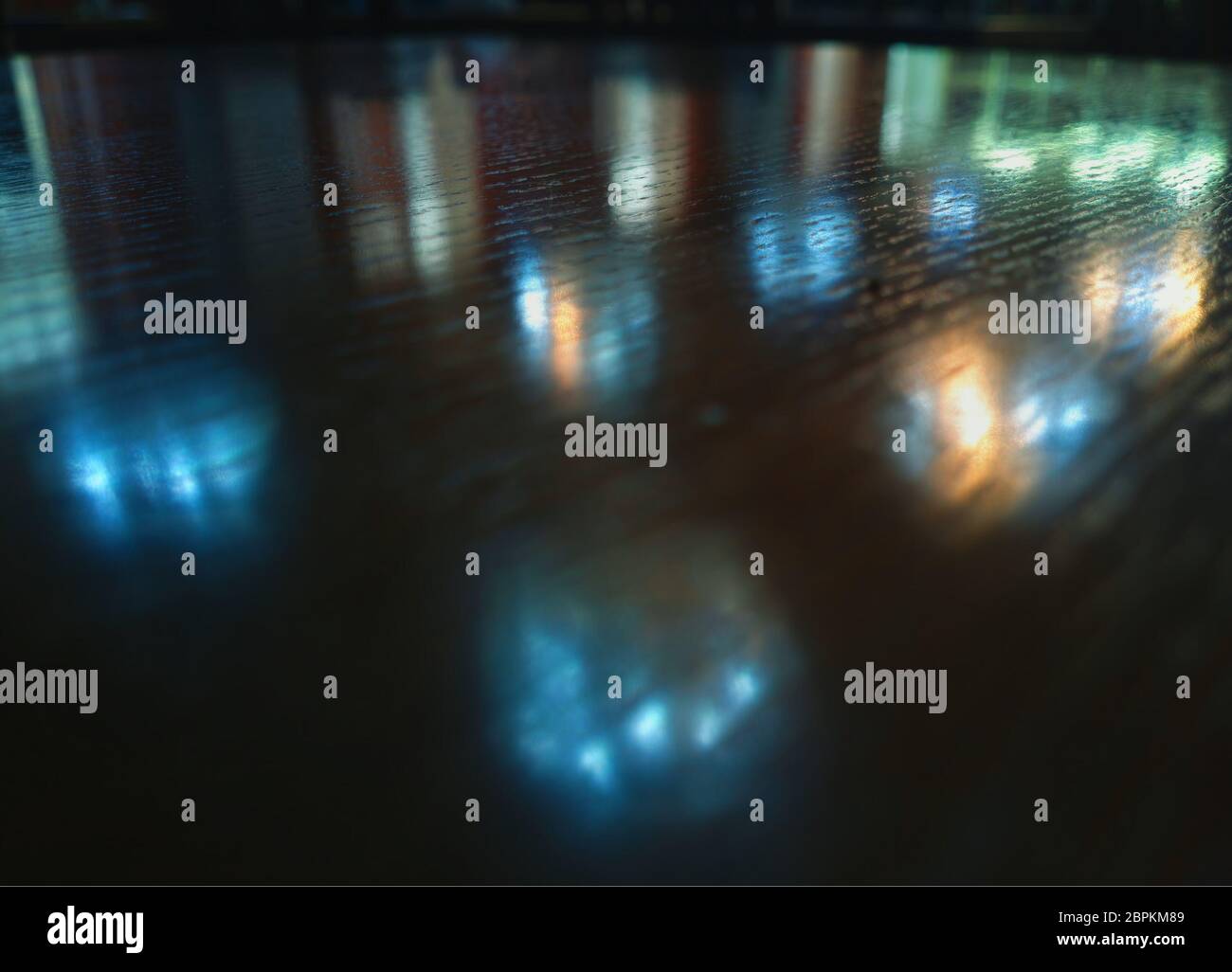 Dramatic reflection on the wooden table background Stock Photo - Alamy