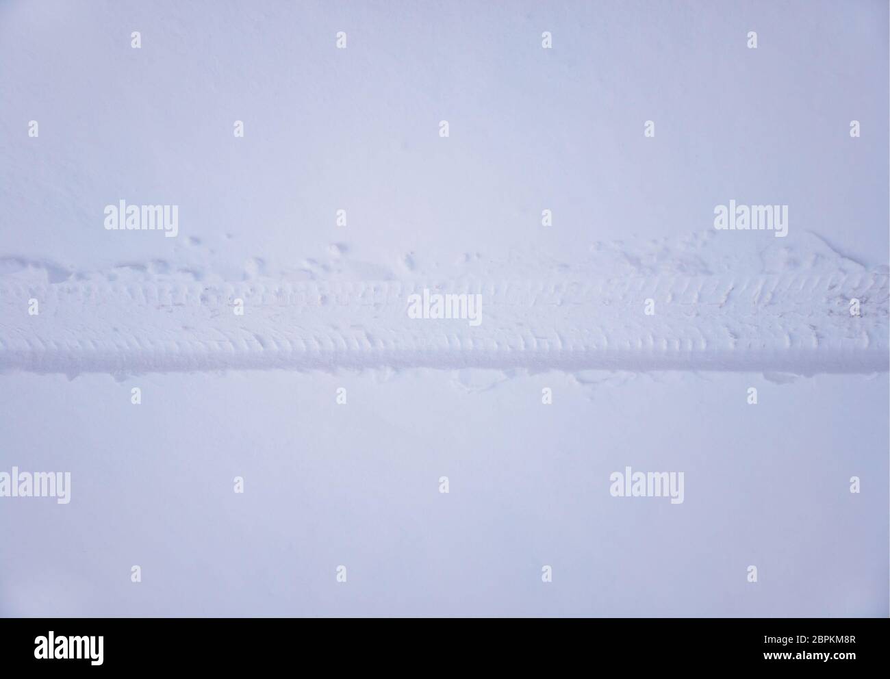Horizontal wheel track on snow background Stock Photo - Alamy