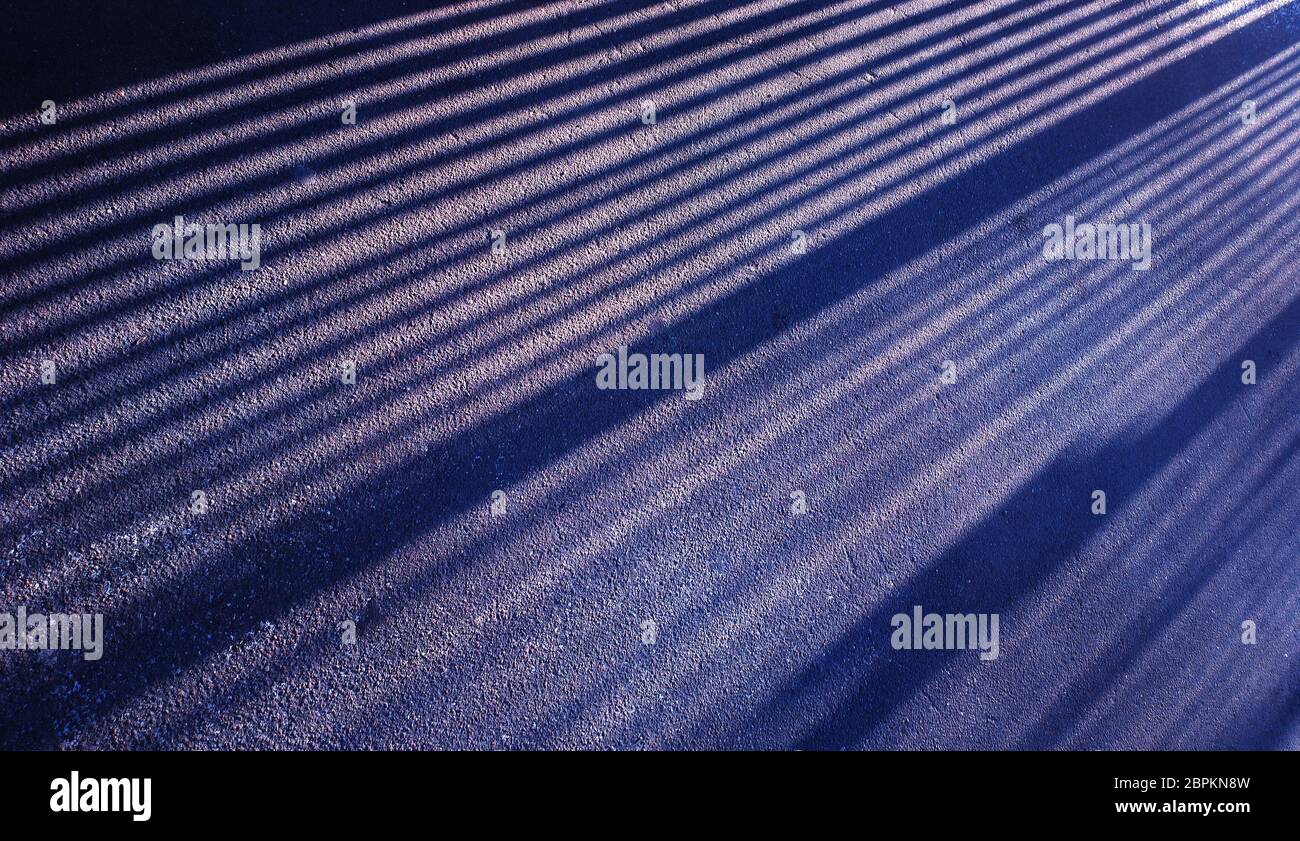Diagonal shadows coming from street fence Stock Photo - Alamy