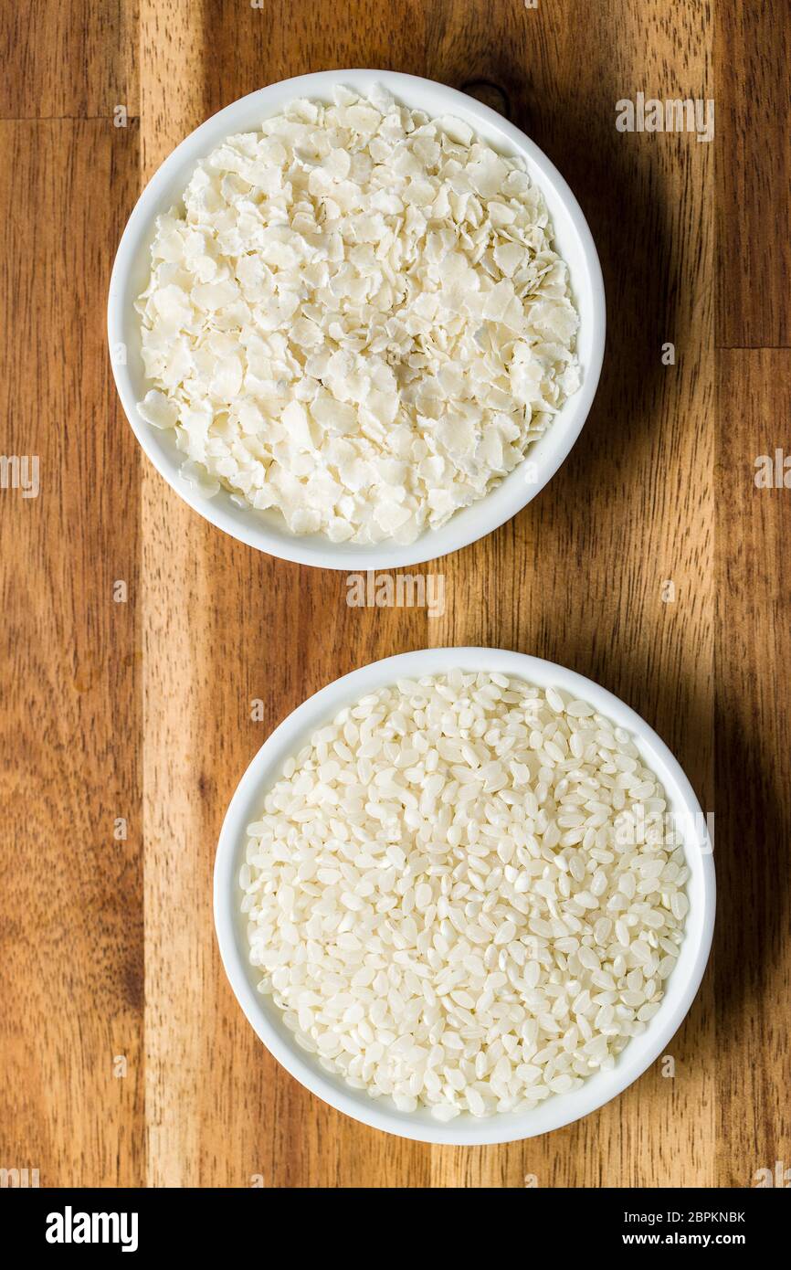 Rice and rice flakes in bowl. top view Stock Photo - Alamy