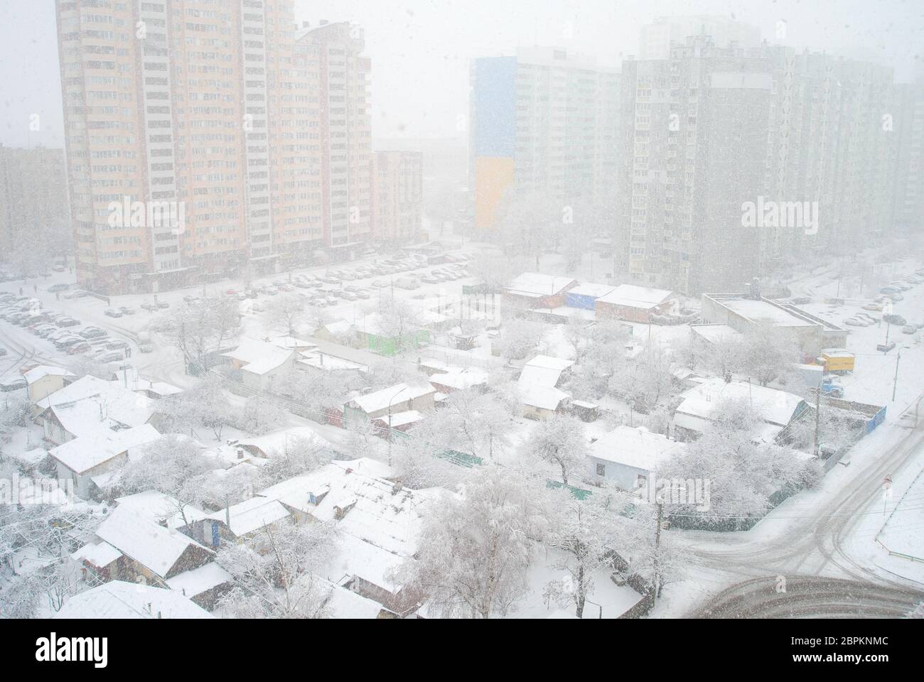 Winter snowfall in residential area with contrast of urban modern ...