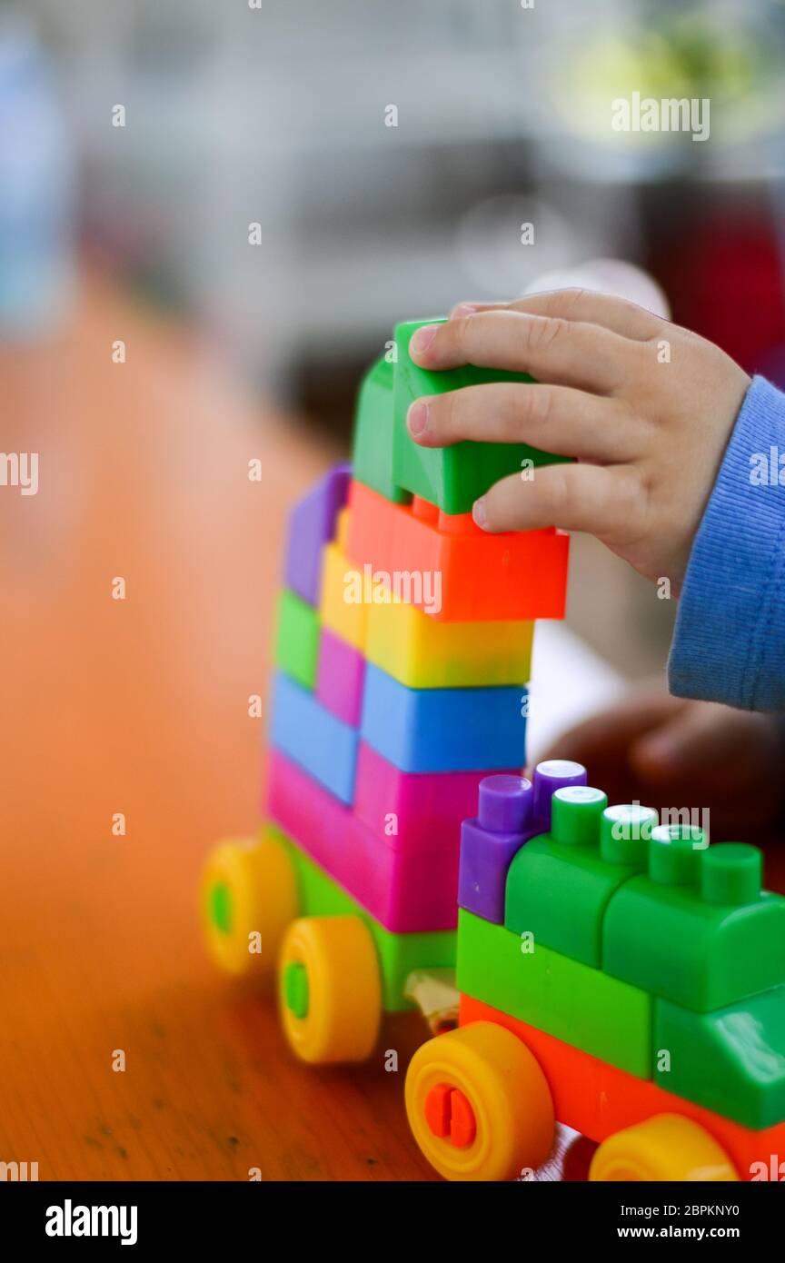 Baby playing and discovery with colorful toys at home, close-up detail ...