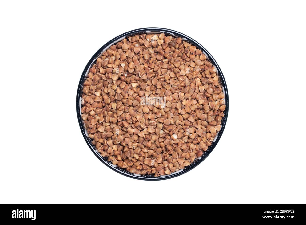Vegetable food. Macro of a bowl of uncooked raw brown buckwheat grains ...