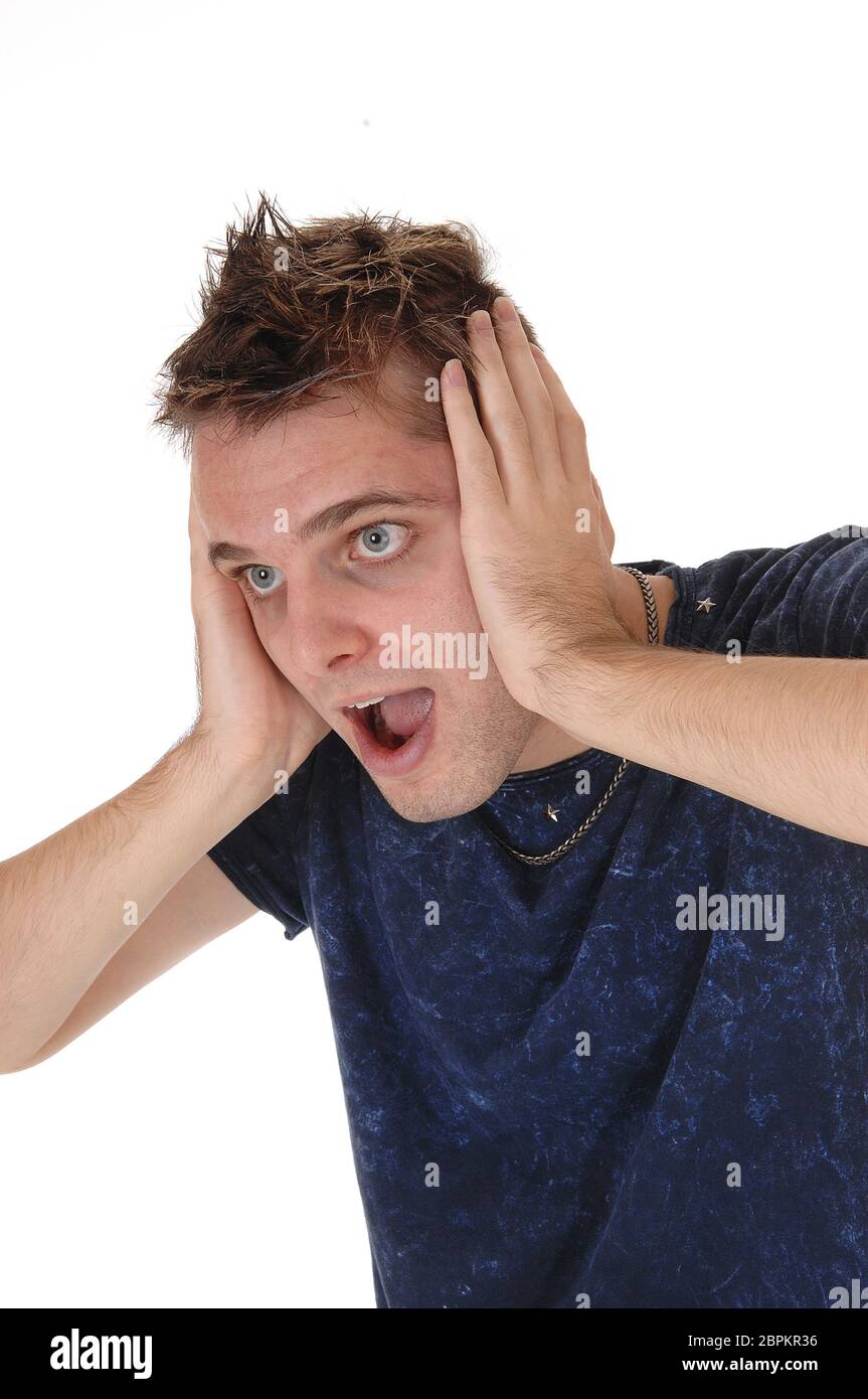 A close up image of a young man standing and screaming with both hand ...