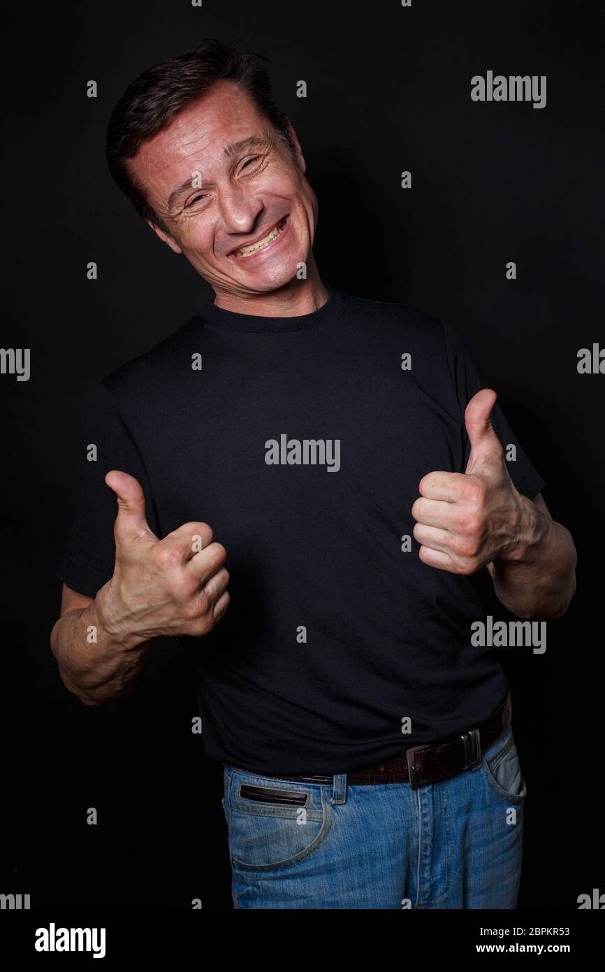 Happy man shows the sign with his hands Perfectly, on a black ...