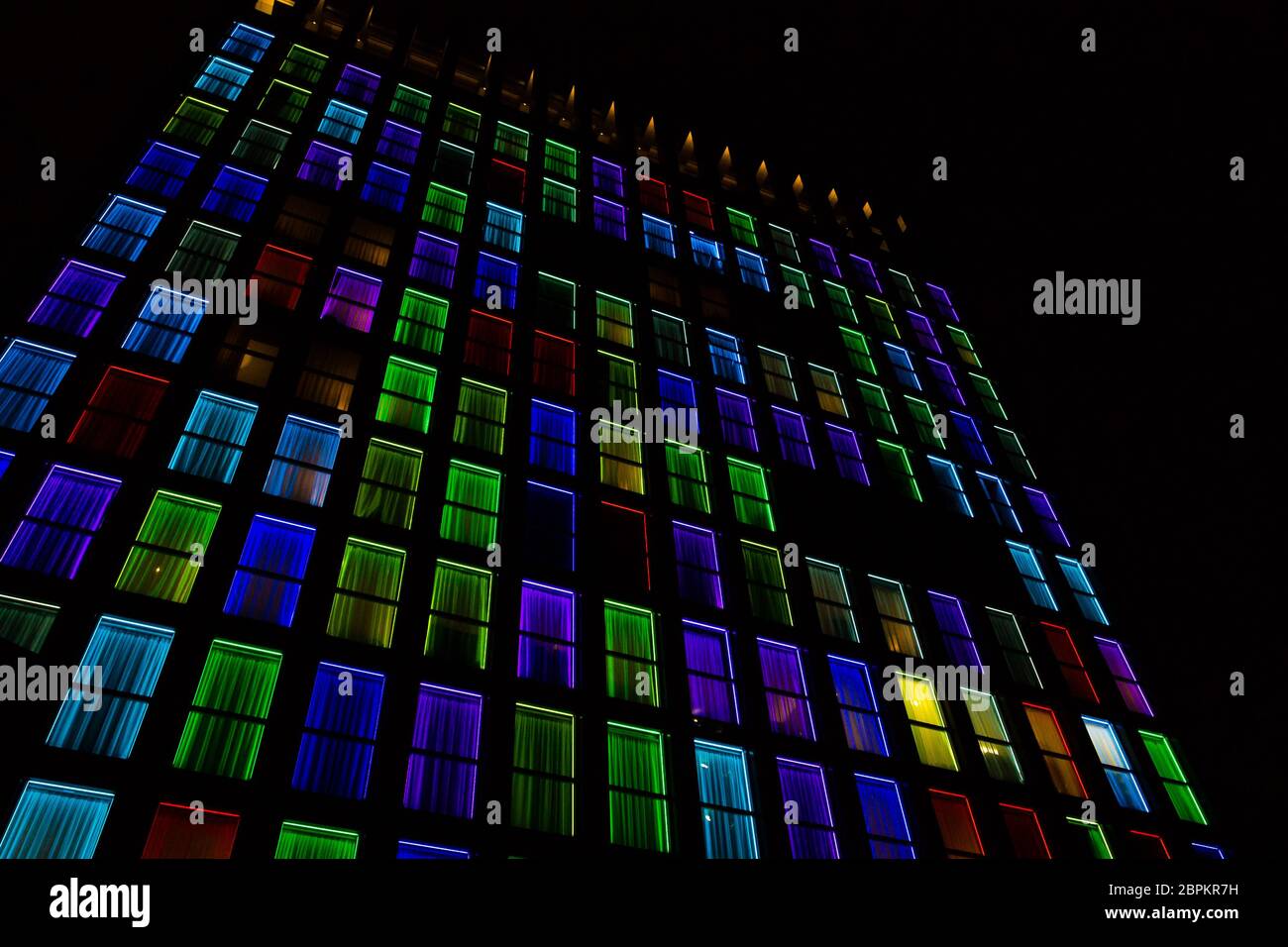 Colored windows texture. Windows illuminated by neon lights background ...