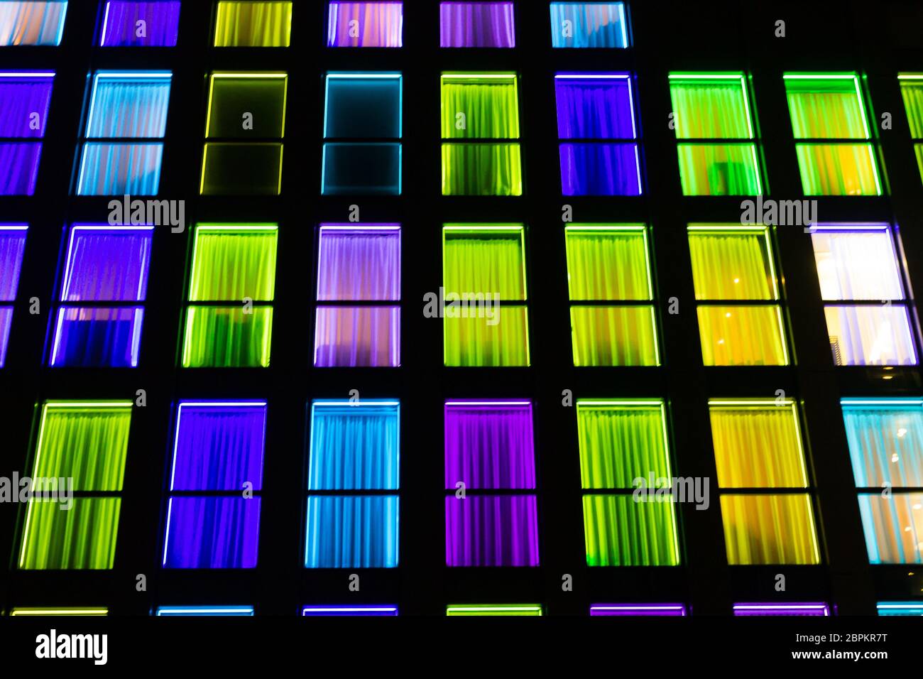 Colored windows texture. Windows illuminated by neon lights background ...