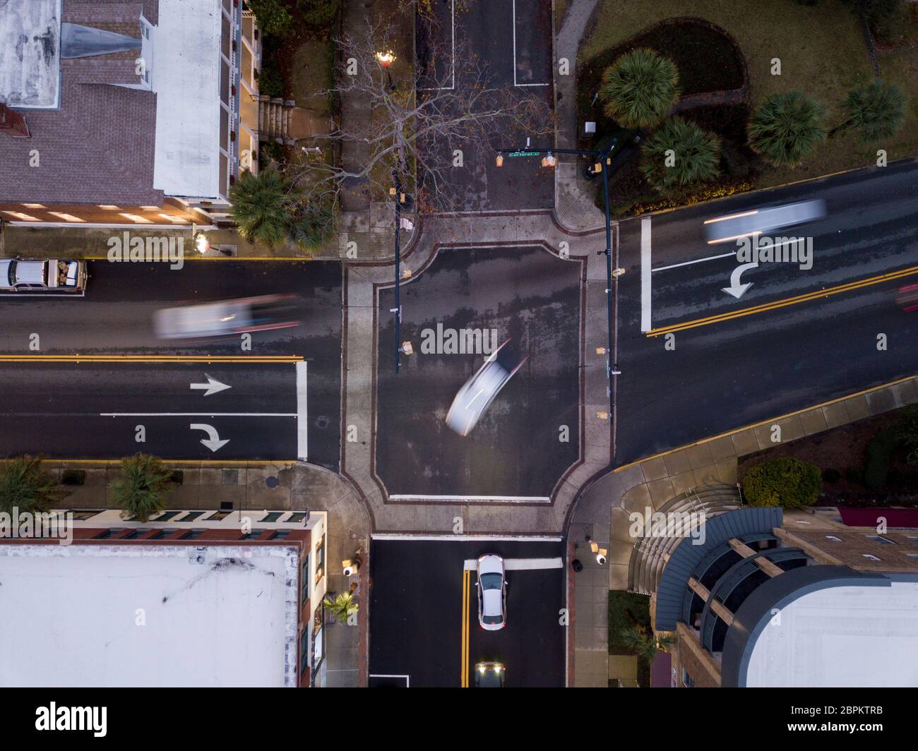View from above of traffic intersection with motion blur cars turning ...