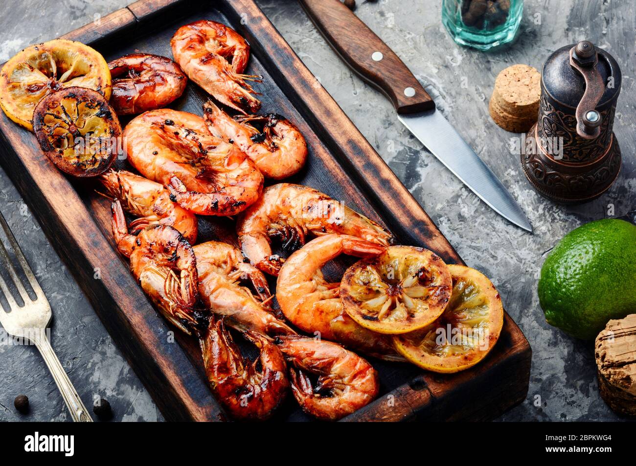 Roasted prawns on wooden cutting board.Grilled seafood Stock Photo - Alamy