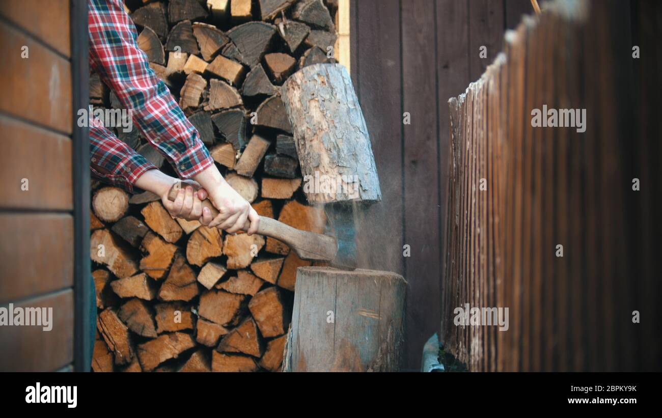 Chopping wood with an ax in woodpile. Mid shot Stock Photo - Alamy