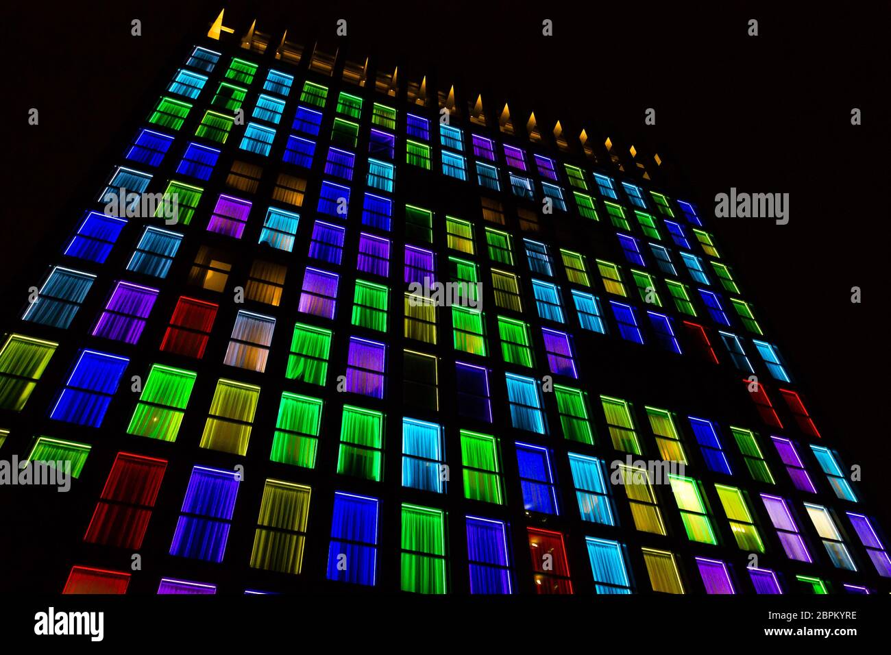 Colored windows texture. Windows illuminated by neon lights background ...