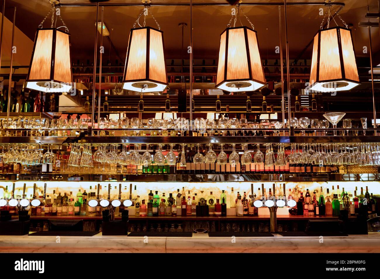 Wide angle shot of a restaurant interior of the bar counter and shelves ...