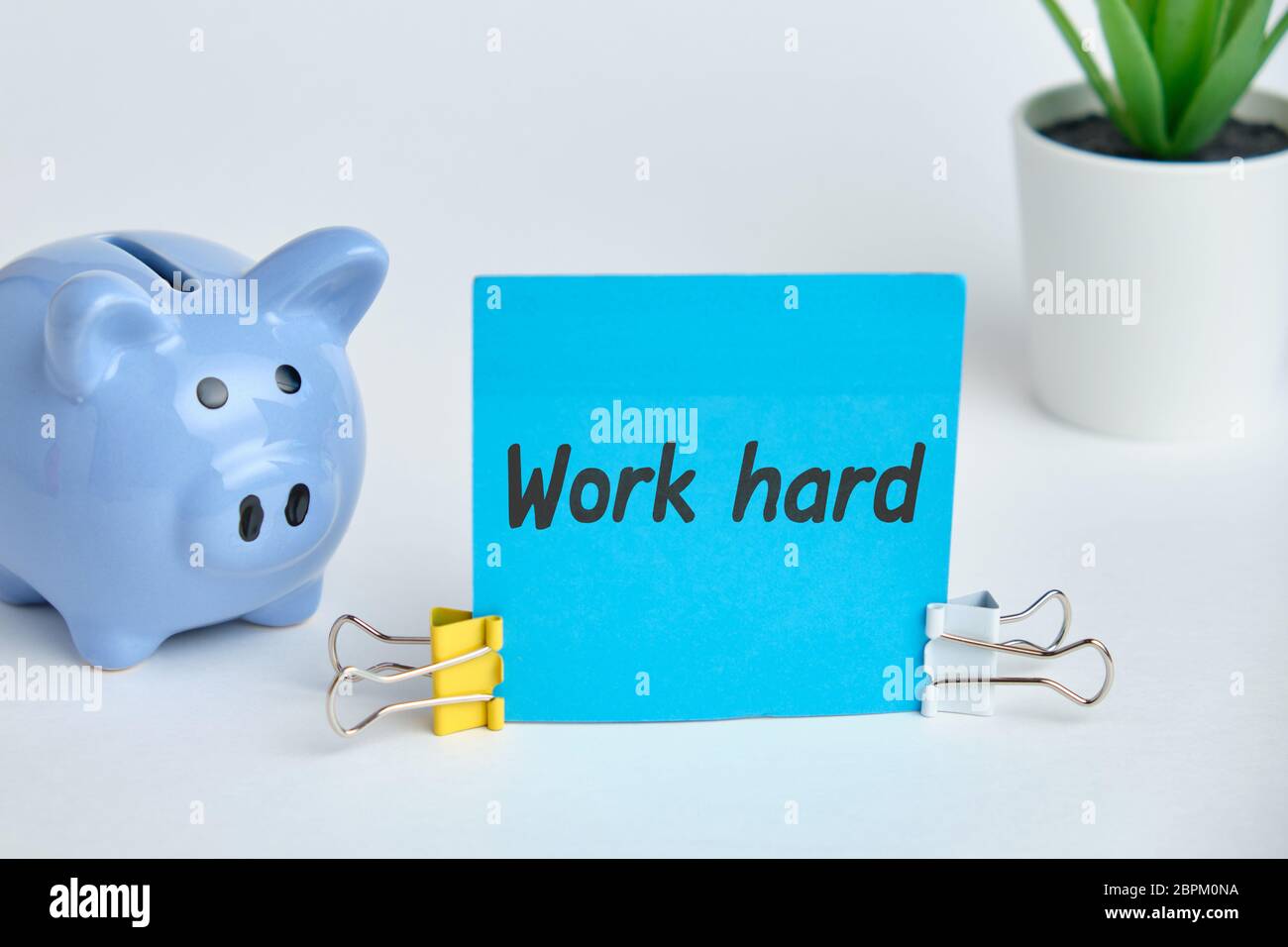 Hand lettering on the sticker work hard on a white background. Close up ...