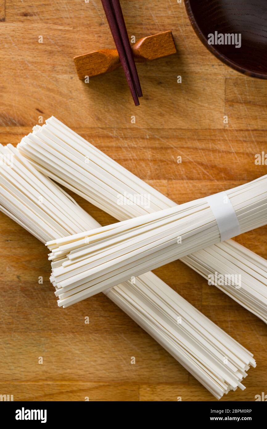Raw udon noodles on wooden table. Top view Stock Photo - Alamy