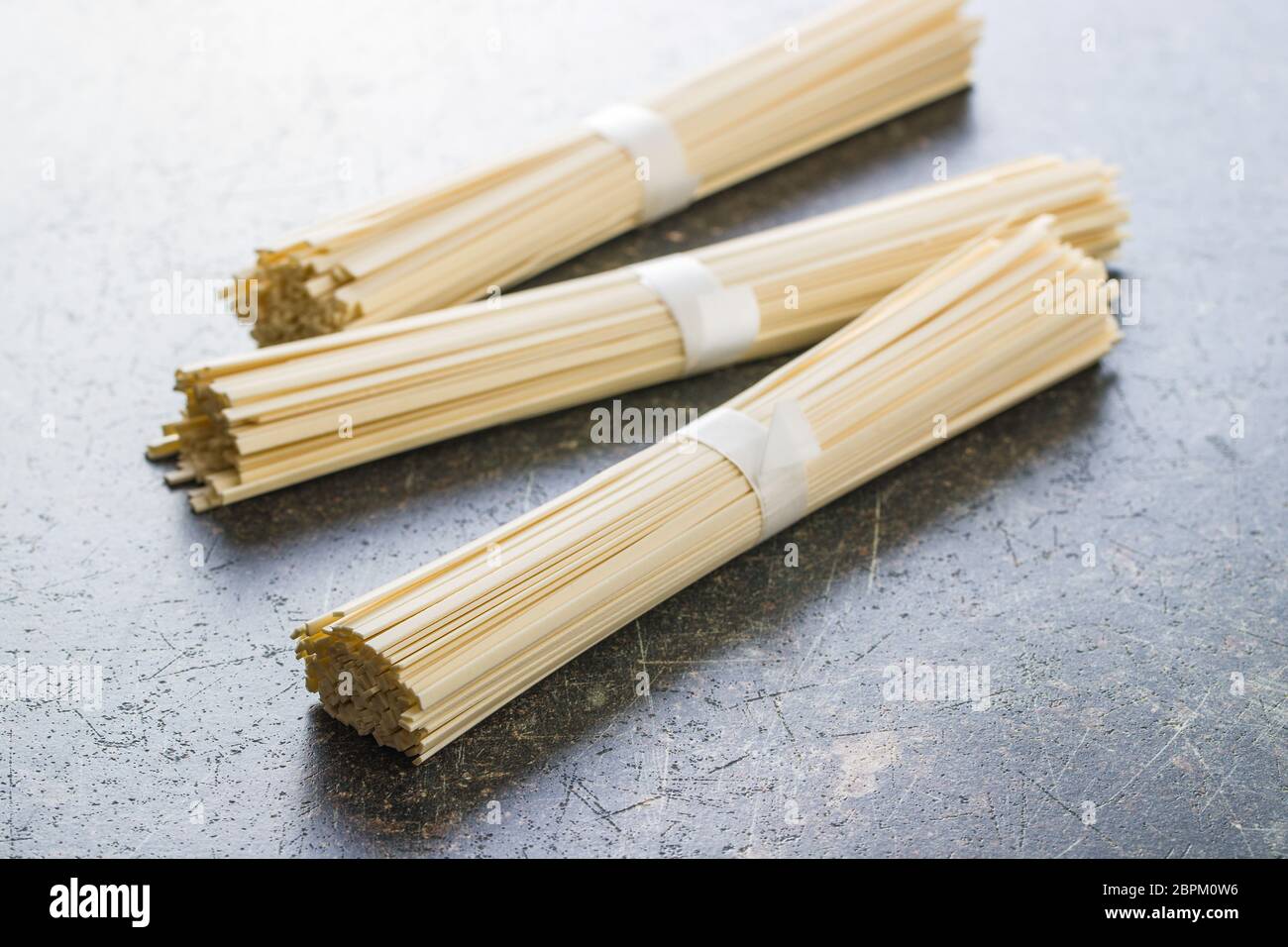 Raw udon noodles on old kitchen table Stock Photo - Alamy