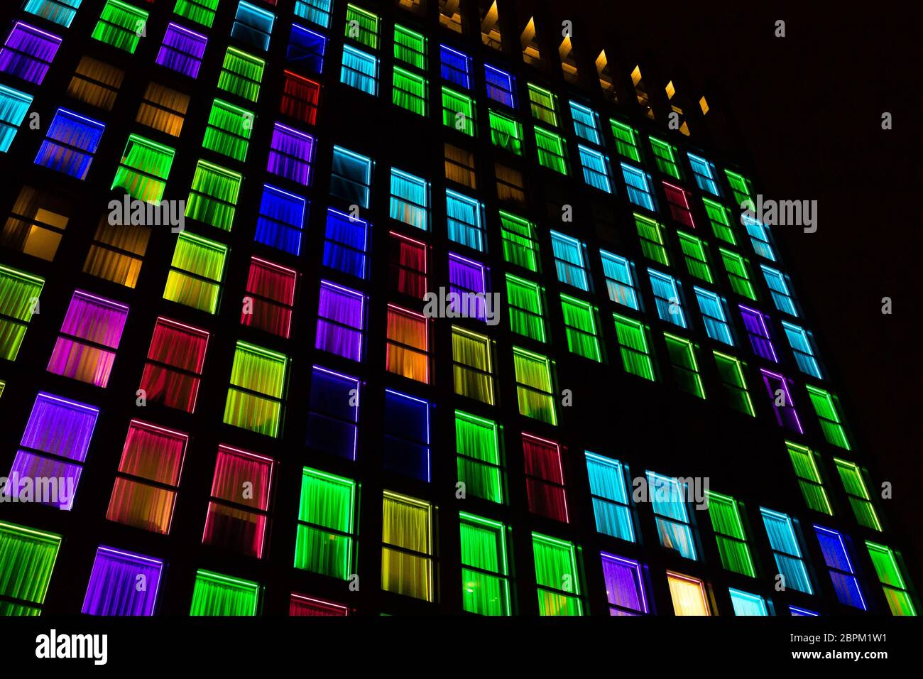 Colored windows texture. Windows illuminated by neon lights background ...