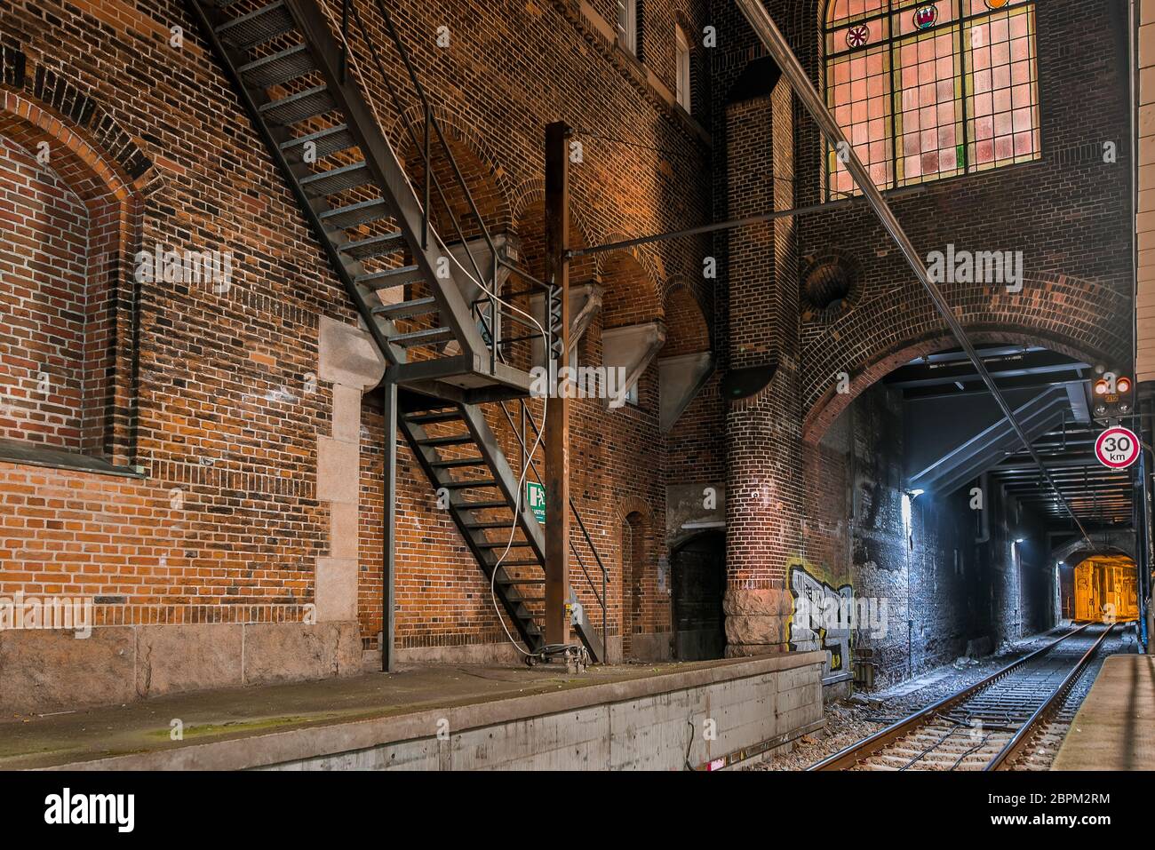 Train-tunnel with brick walls and in diferent light, inside the cental ...