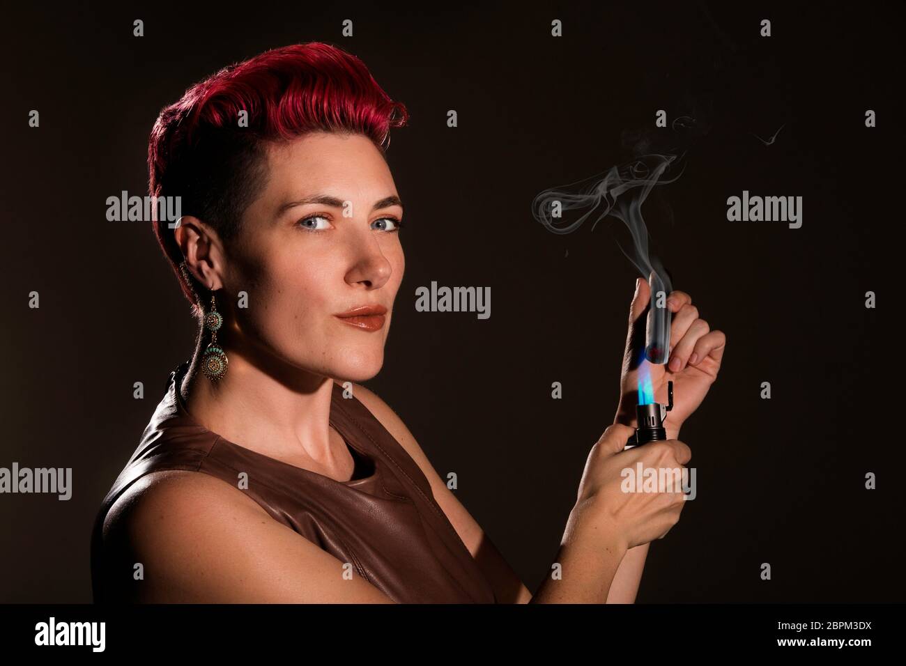 Woman lighting a cigar hi-res stock photography and images - Alamy