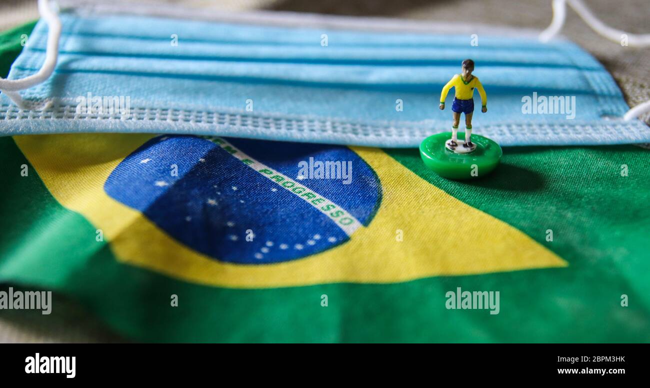 flag of Brazil and surgical mask with a plastic football player for ...