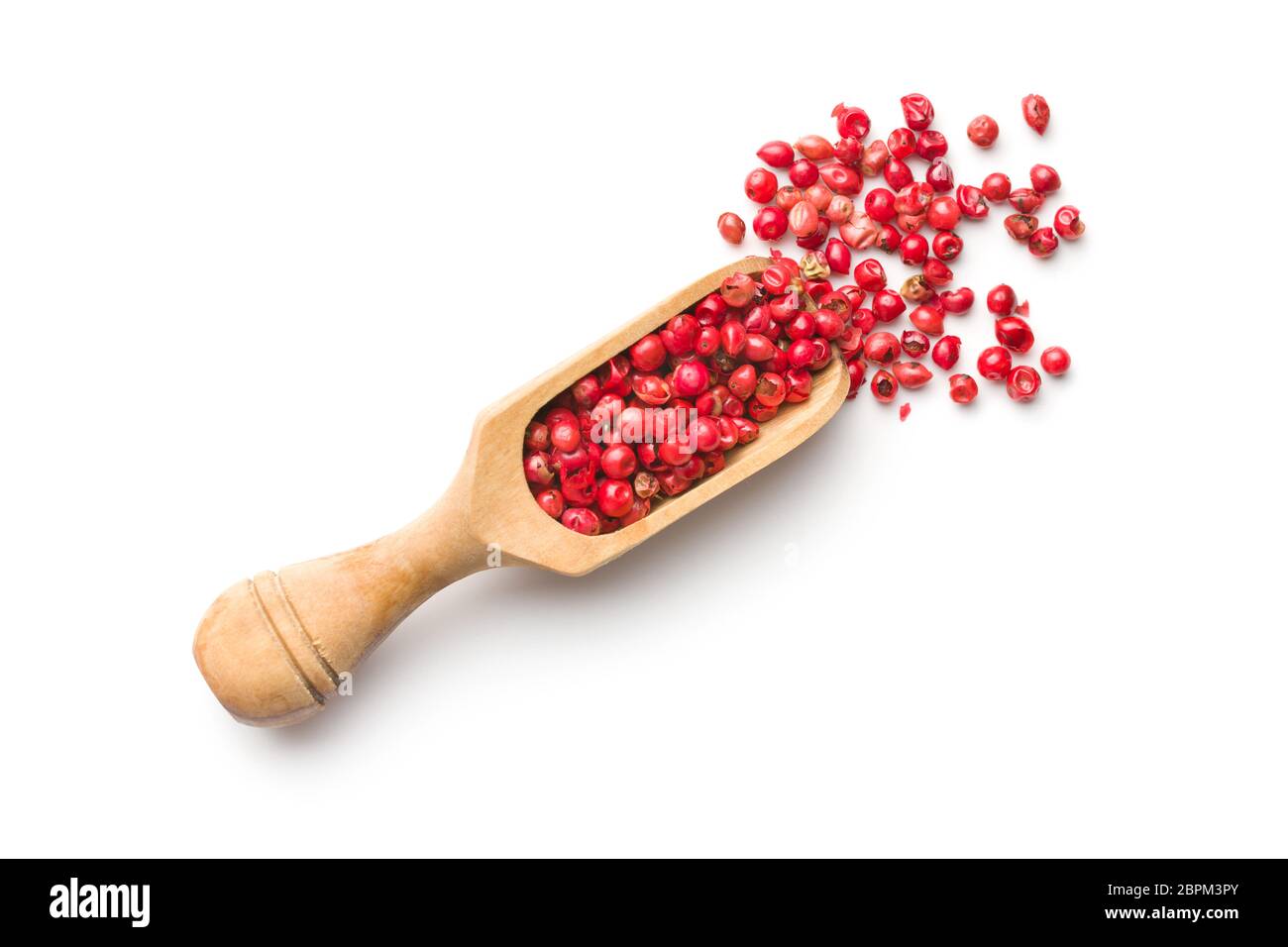 Dried pink peppercorn in wooden scoop isolated on white background ...