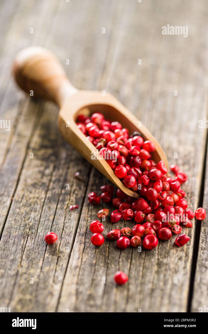 Dried pink peppercorn in wooden scoop Stock Photo - Alamy