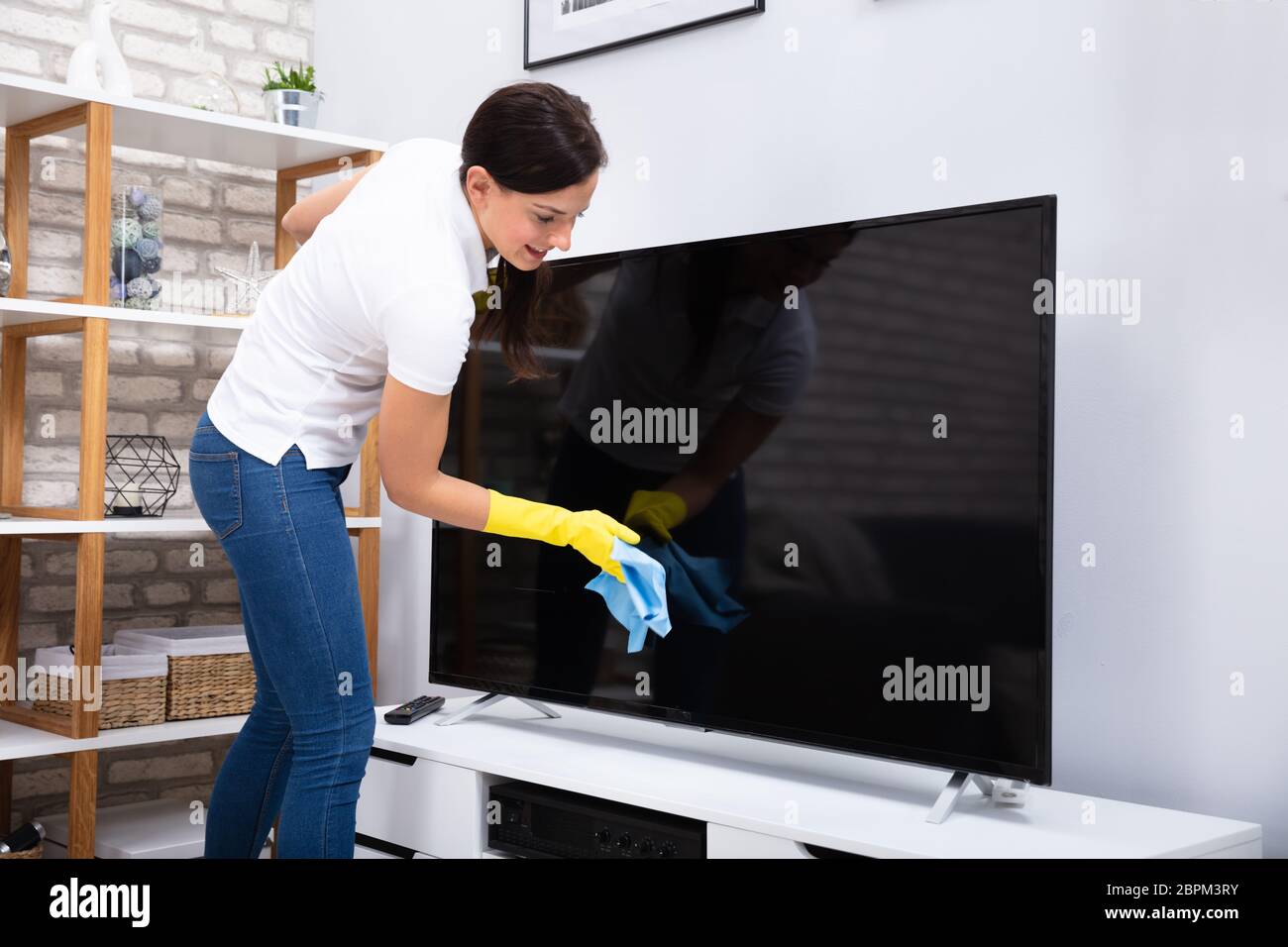 Woman standing tv wall hi-res stock photography and images - Alamy