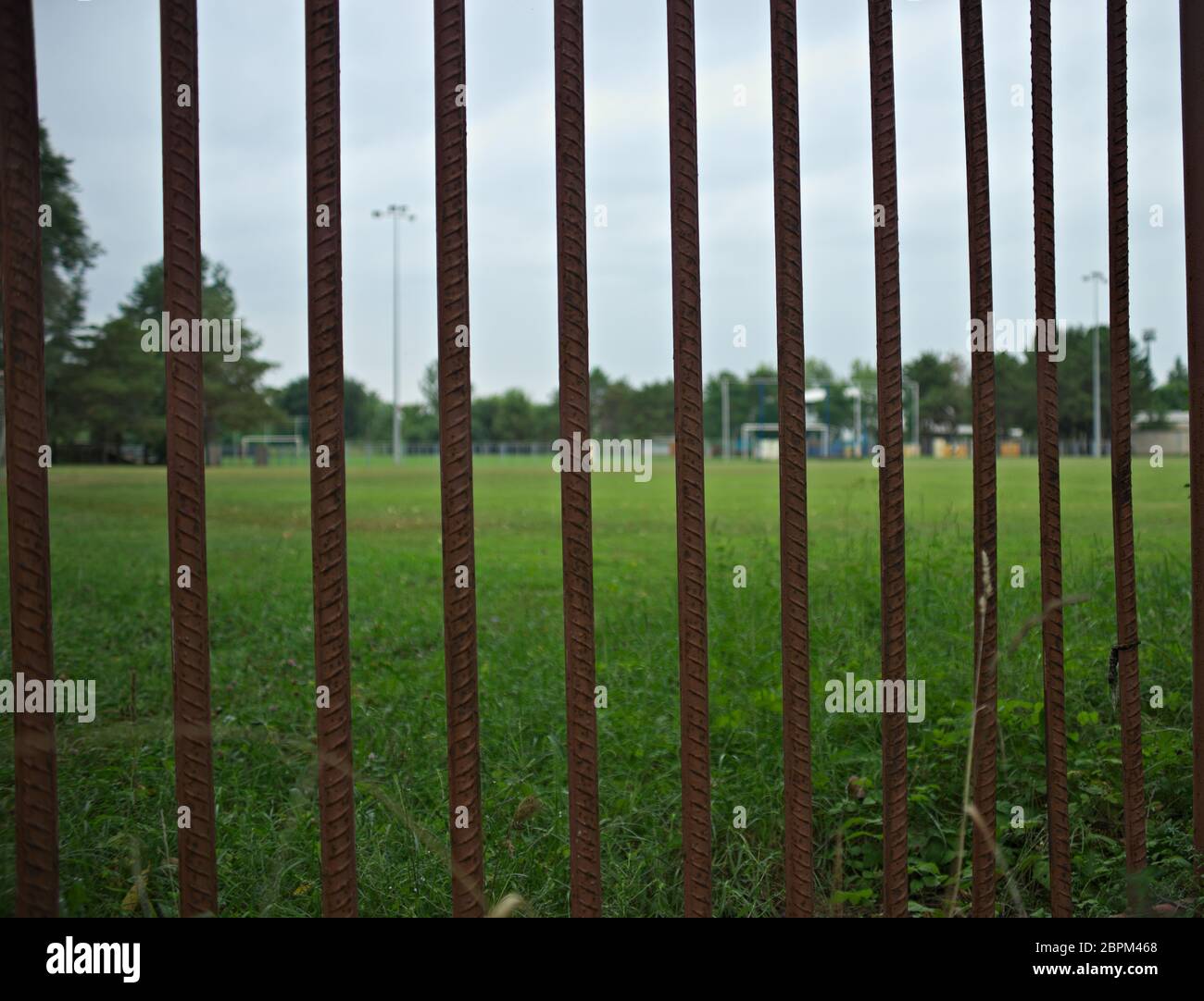 Entrance gate bars to a football field Stock Photo - Alamy