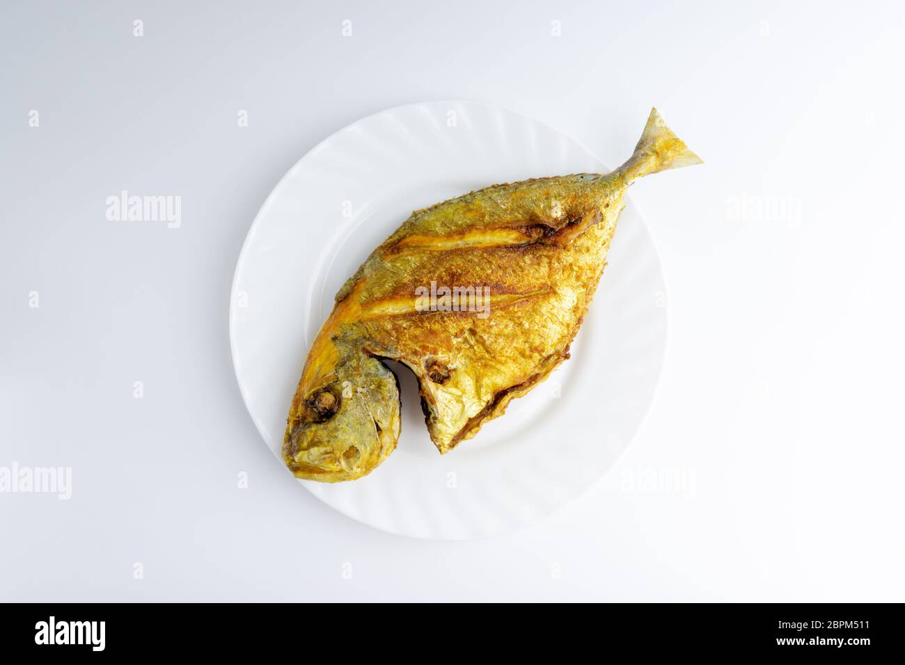 Fried fish on white background with selective focus Stock Photo - Alamy