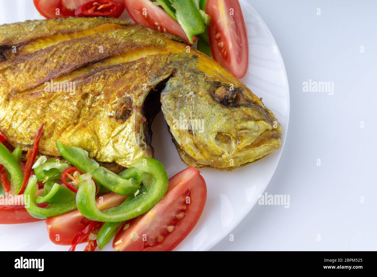 Fried fish on white background with selective focus Stock Photo - Alamy