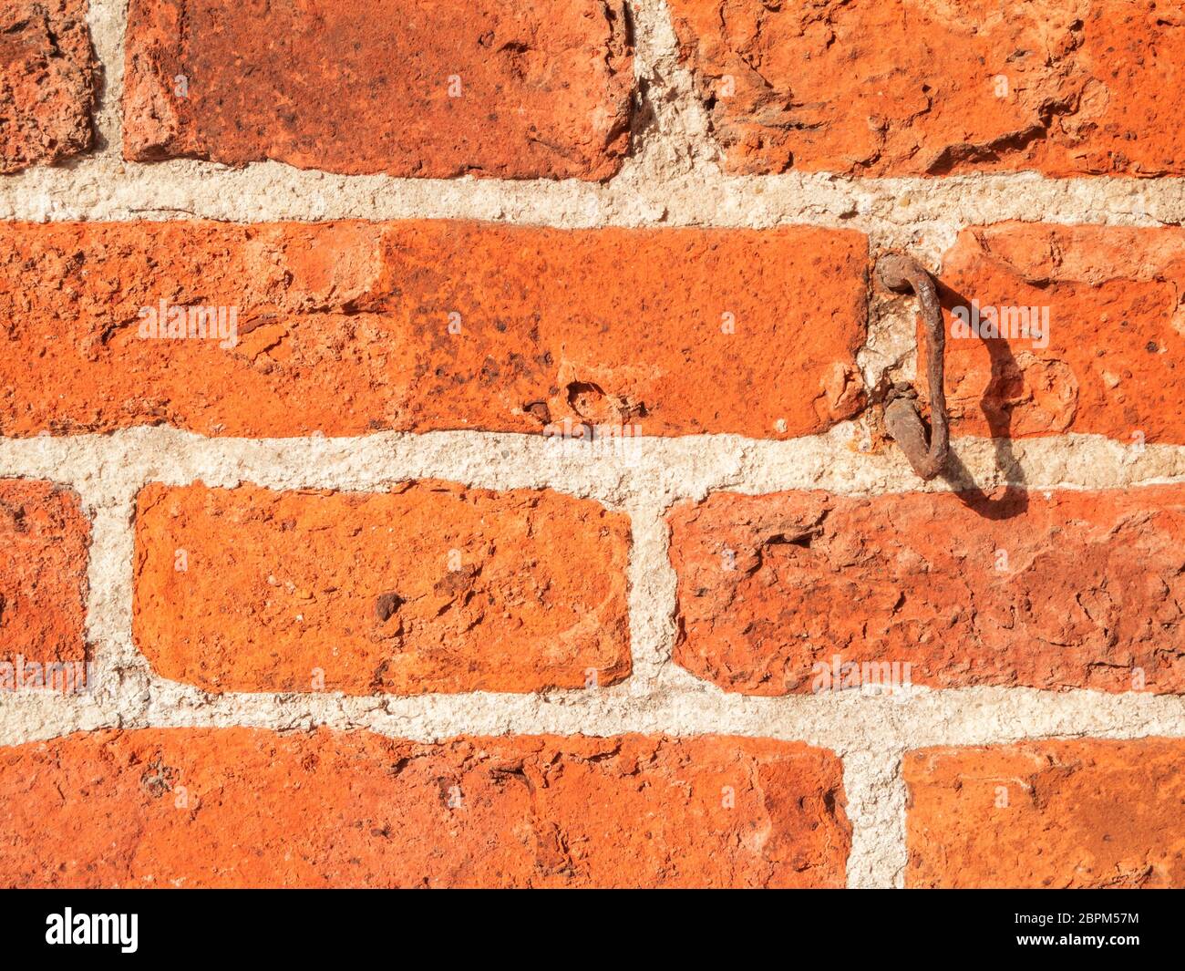 Full frame closeup of a weathered bricks wall with a single rusted ...