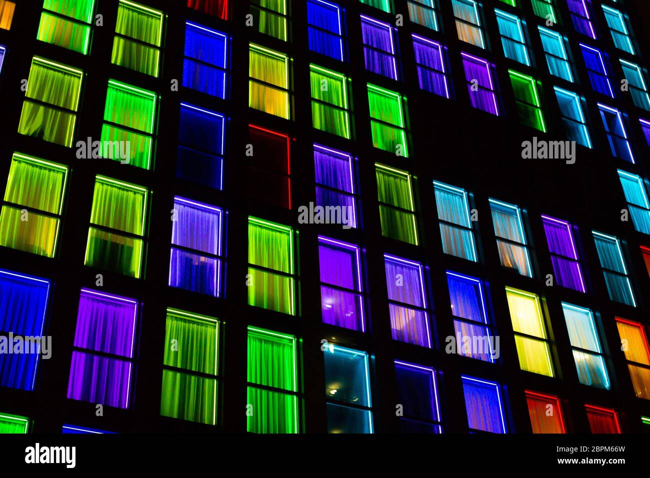 Colored windows texture. Windows illuminated by neon lights background ...