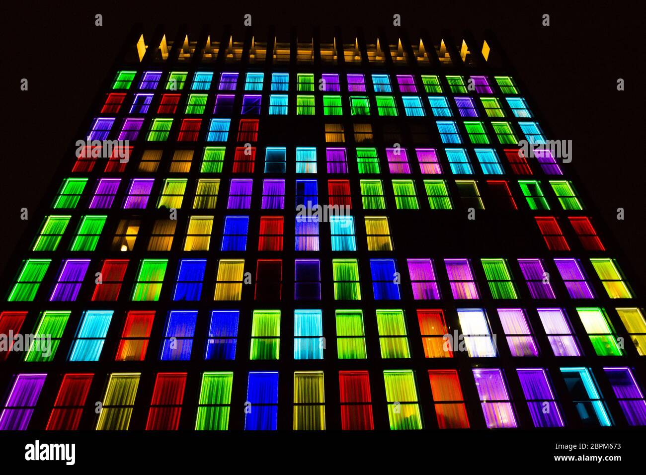 Colored windows texture. Windows illuminated by neon lights background ...