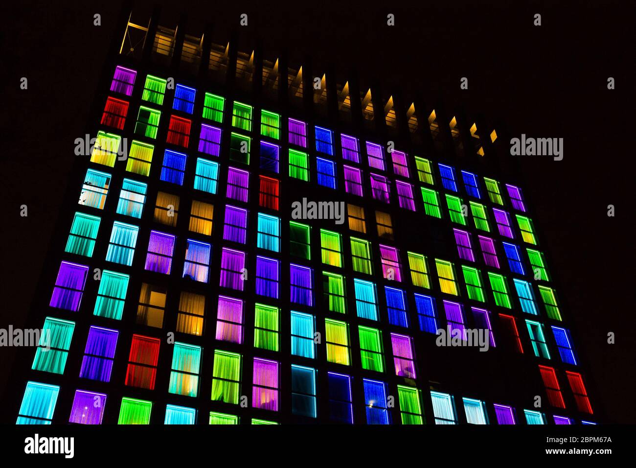 Colored windows texture. Windows illuminated by neon lights background ...