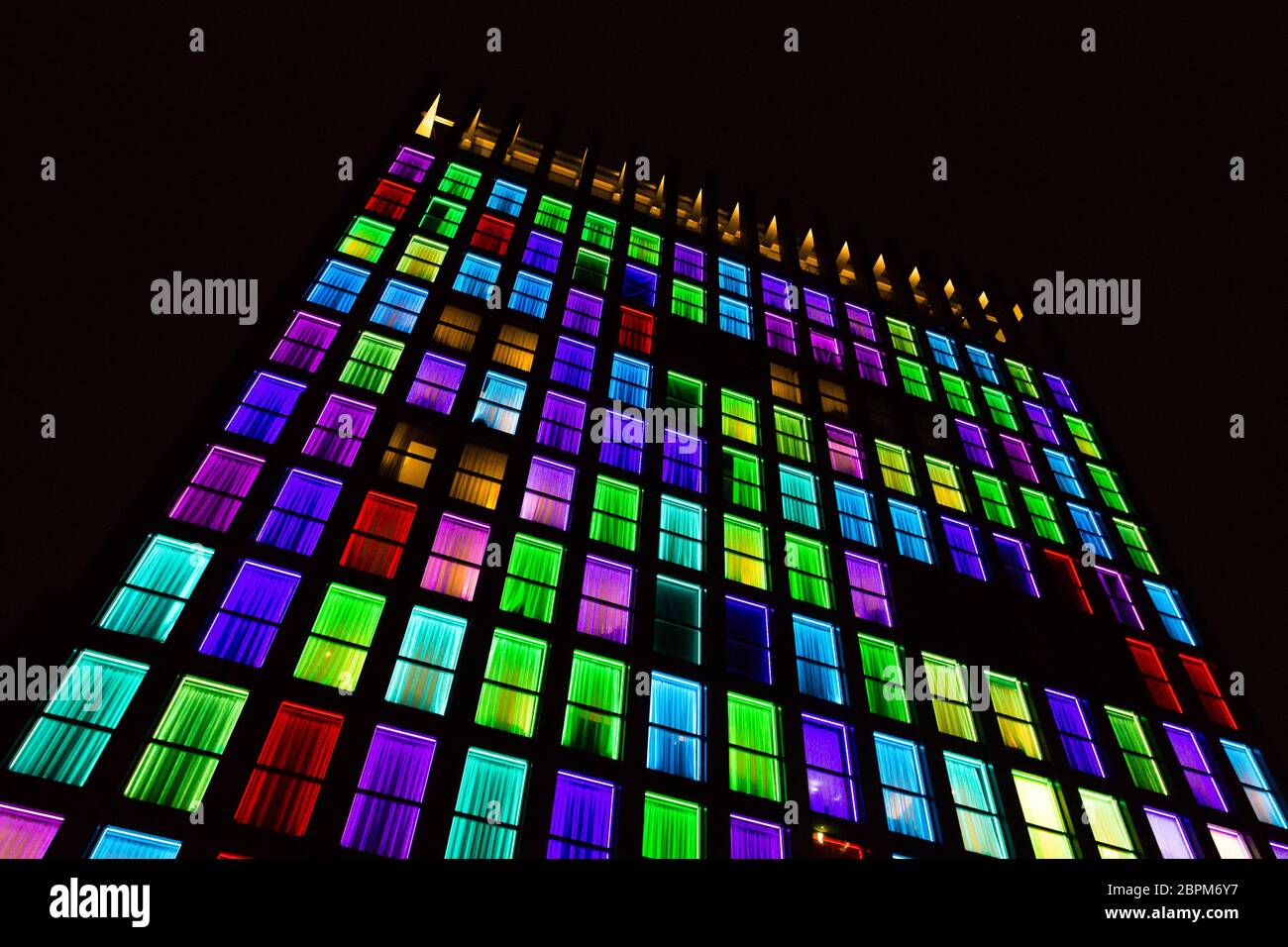 Colored windows texture. Windows illuminated by neon lights background ...