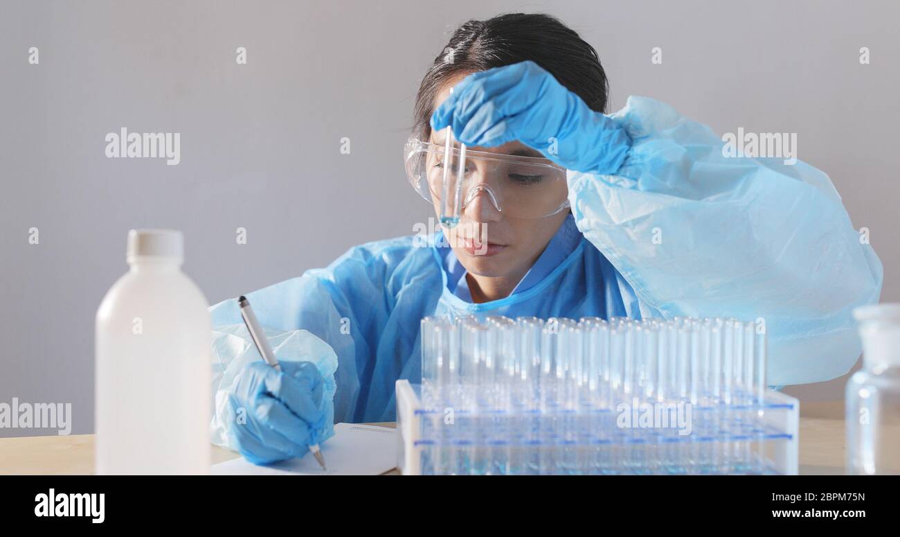 Female scientist mixing chemical solution hi-res stock photography and ...
